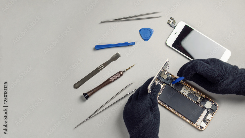 Technician or engineer disassembling components broken smartphone for ...