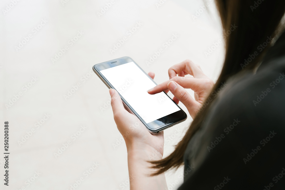 Girl holding smartphone with white empty screen. Closeup female finger ...