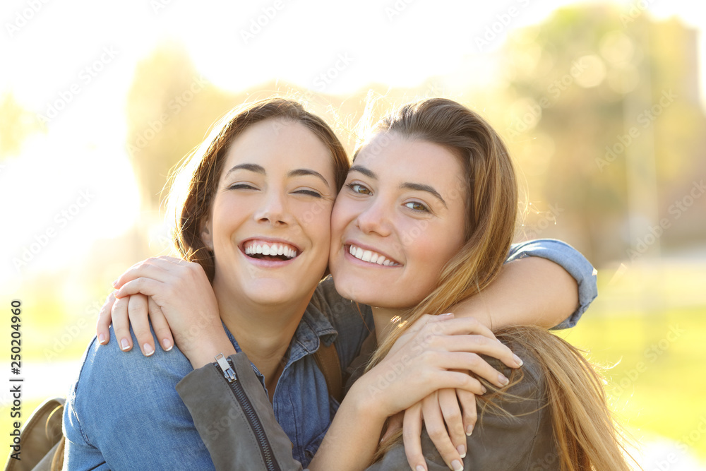 Happy friends with perfect smile cuddling looking at you Stock Photo ...