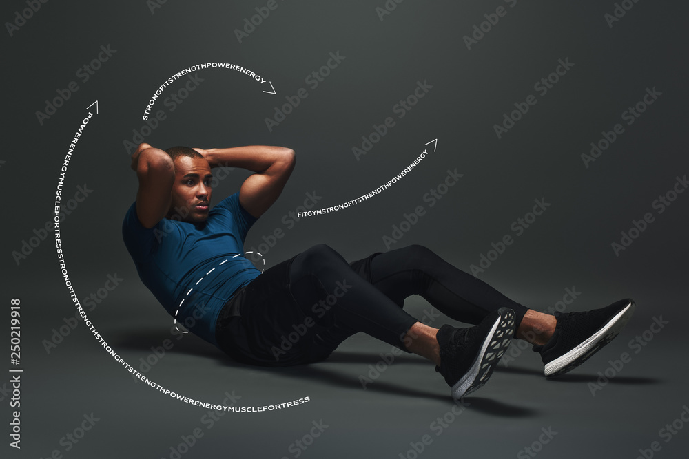 Strong body. Sportsman lying over dark background, working abs. Graphic ...