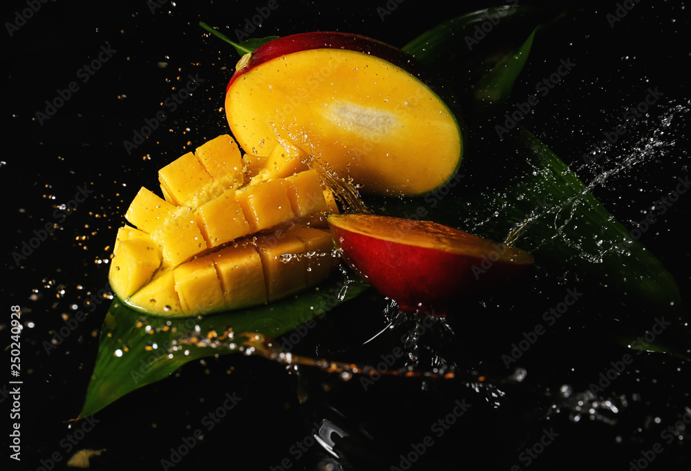 Ripe cut mango with water splash on dark background Stock Photo | Adobe ...