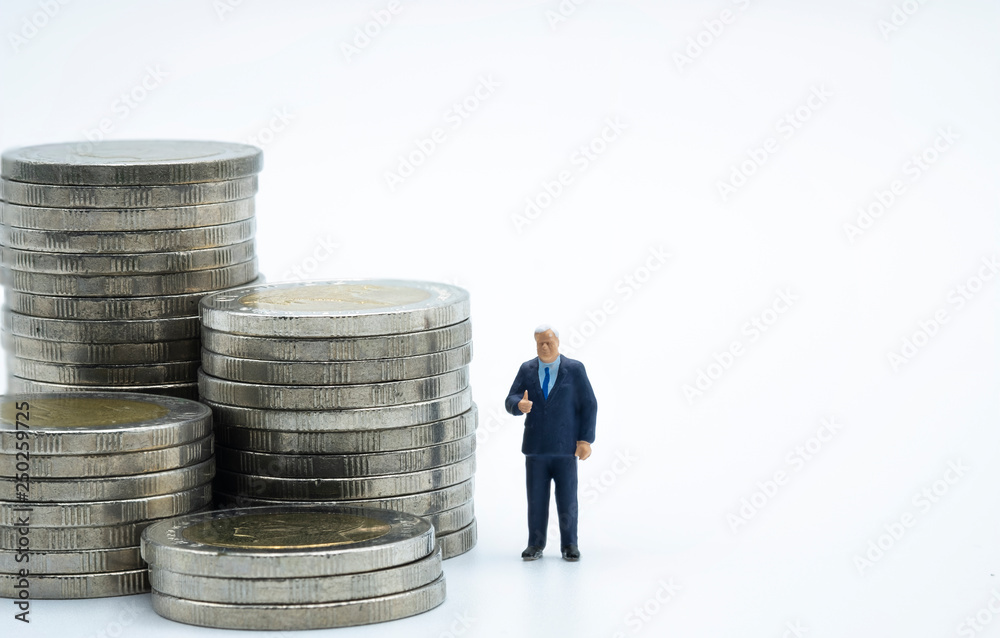 Miniature of Business man manager standing beside coins stacking with ...