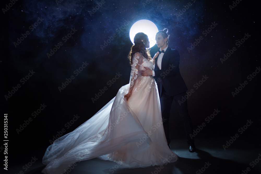 Mysterious and romantic meeting, the bride and groom under the moon ...