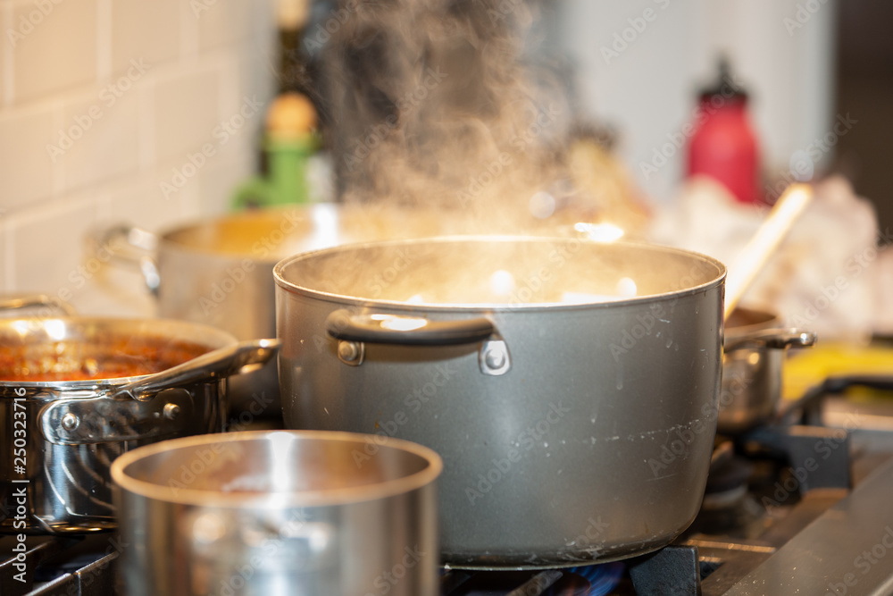 Pots cooking on stove with steam Stock Photo | Adobe Stock