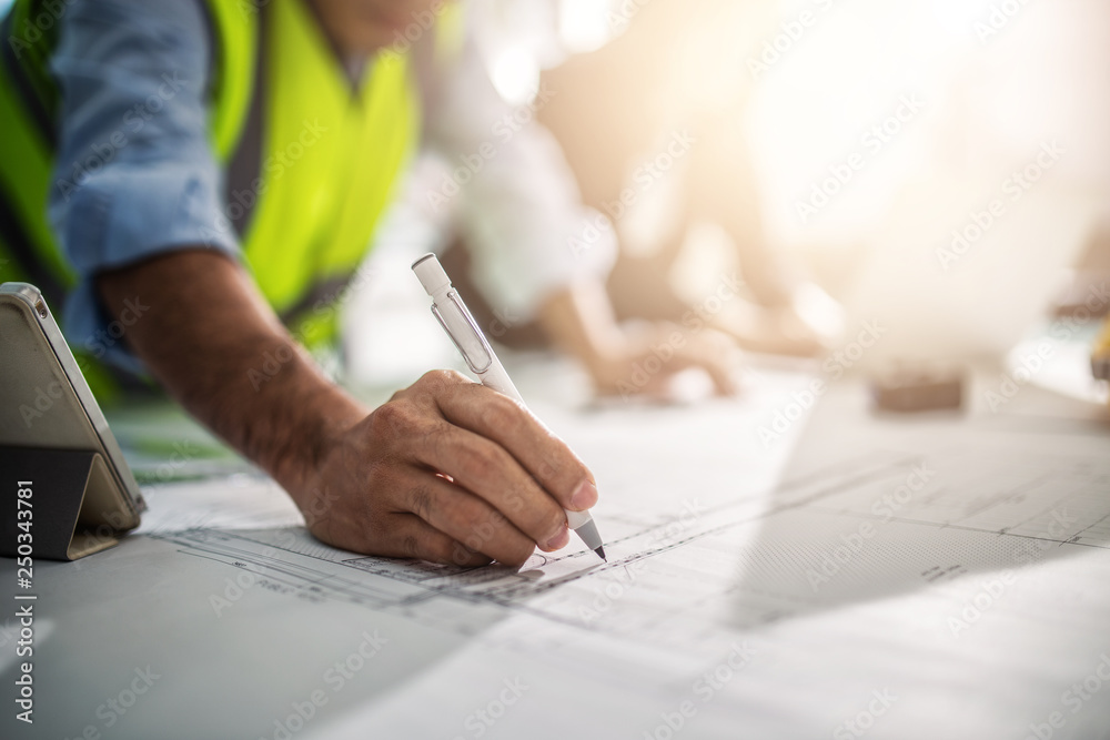 Young male and female architect colleagues drawing graphic planning of ...