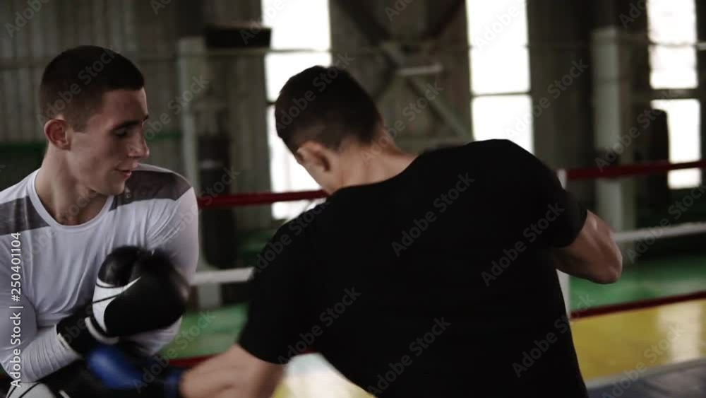 Sparring, training of two young partners of boxers on the ring ...