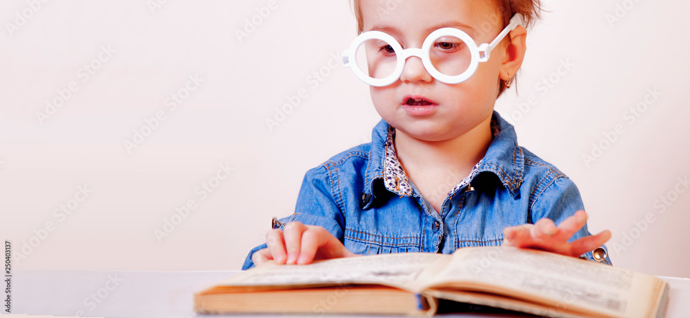 Child girl reading a book as symbol of learning, knowledge and ...