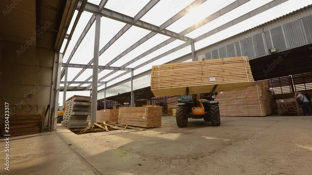 Forklift in a factory, forklift truck transports boards in a factory ...
