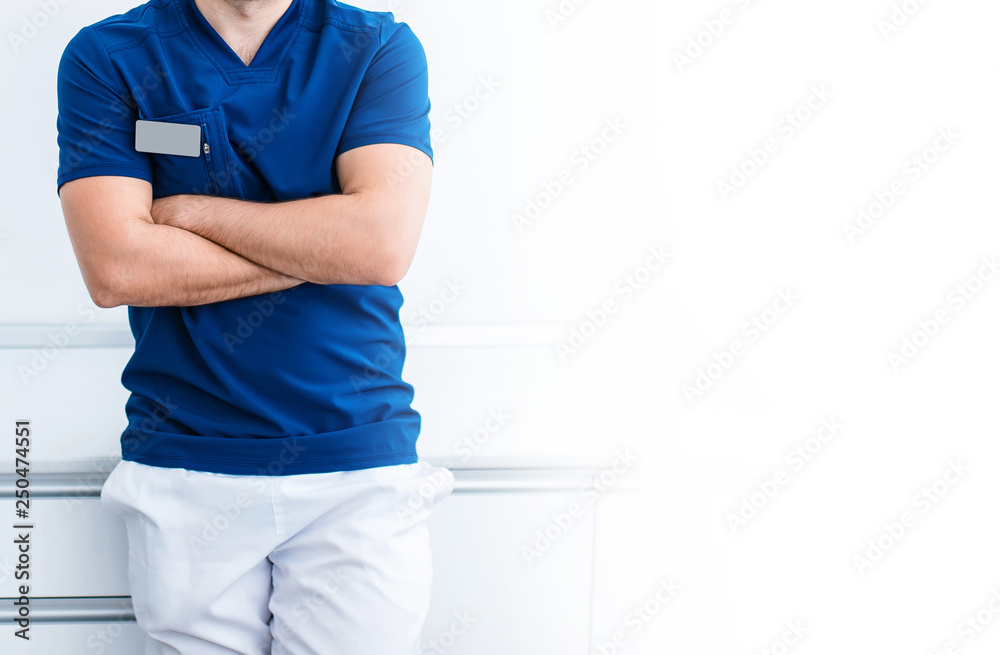 Female doctor standing in white cabinet with his hands crossed. no head ...