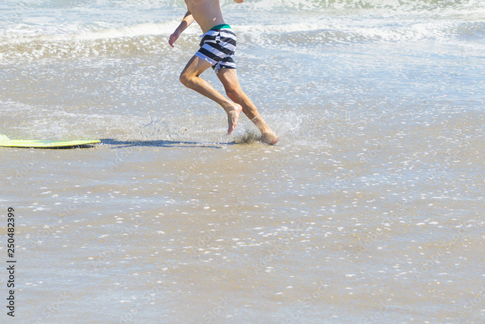 Skim-boarding in shallow water. Stock Photo | Adobe Stock