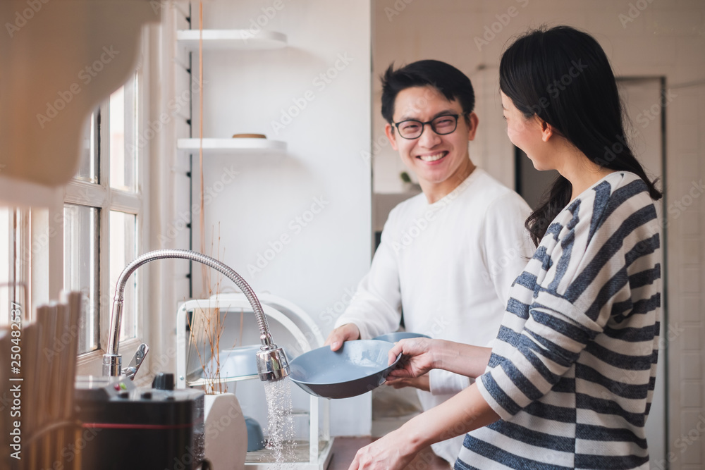 Asian couple family washing dishes together at kitchen Stock Photo ...