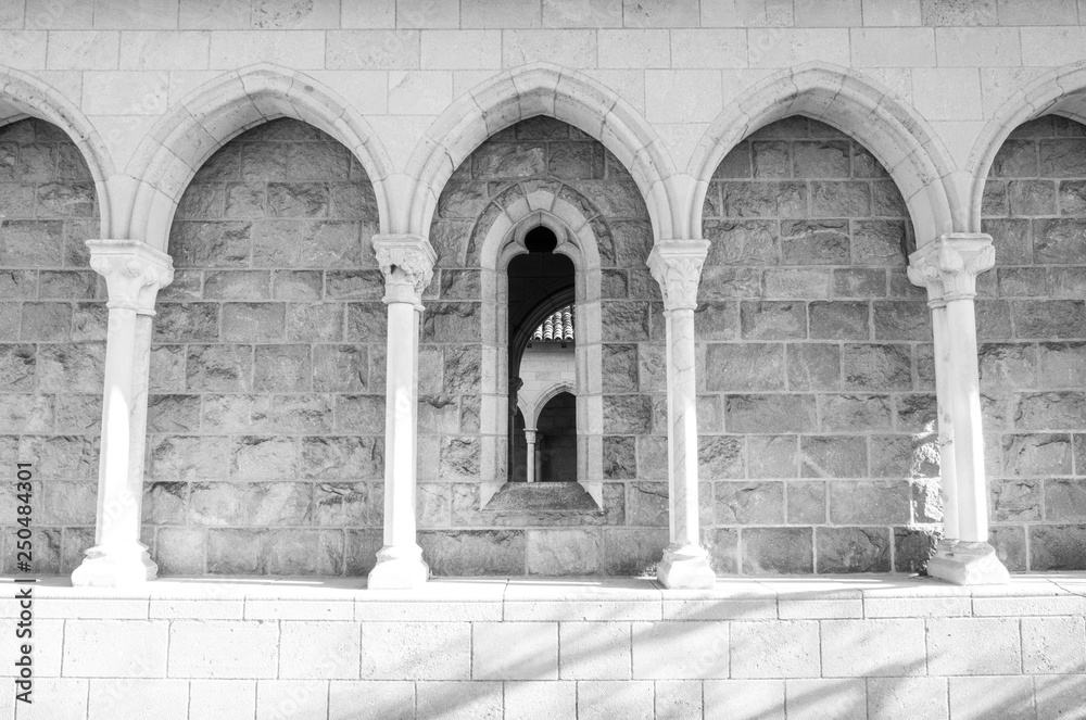 Stone faced castle church gothic facade exterior. Curved arched window ...