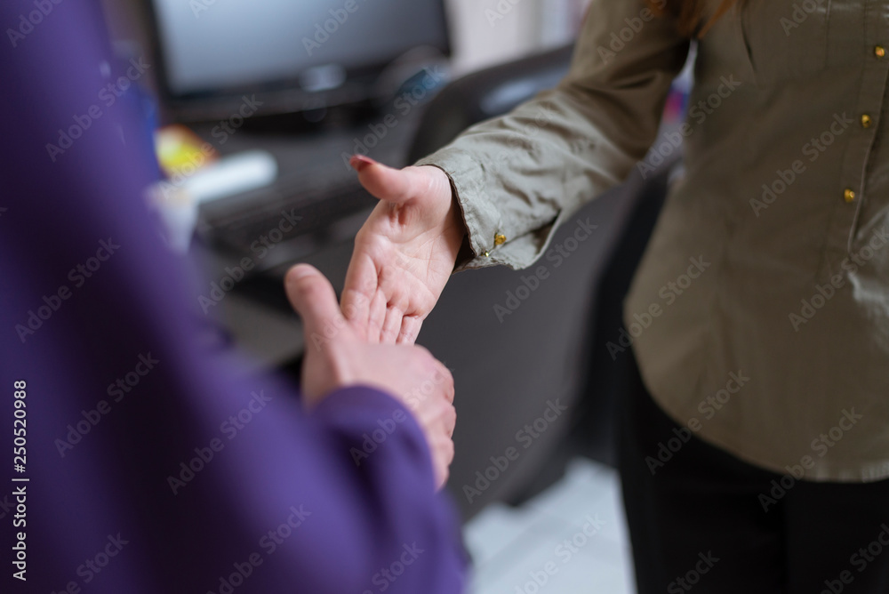 Man and woman handshake, only arms and part of woman's body visible. No ...