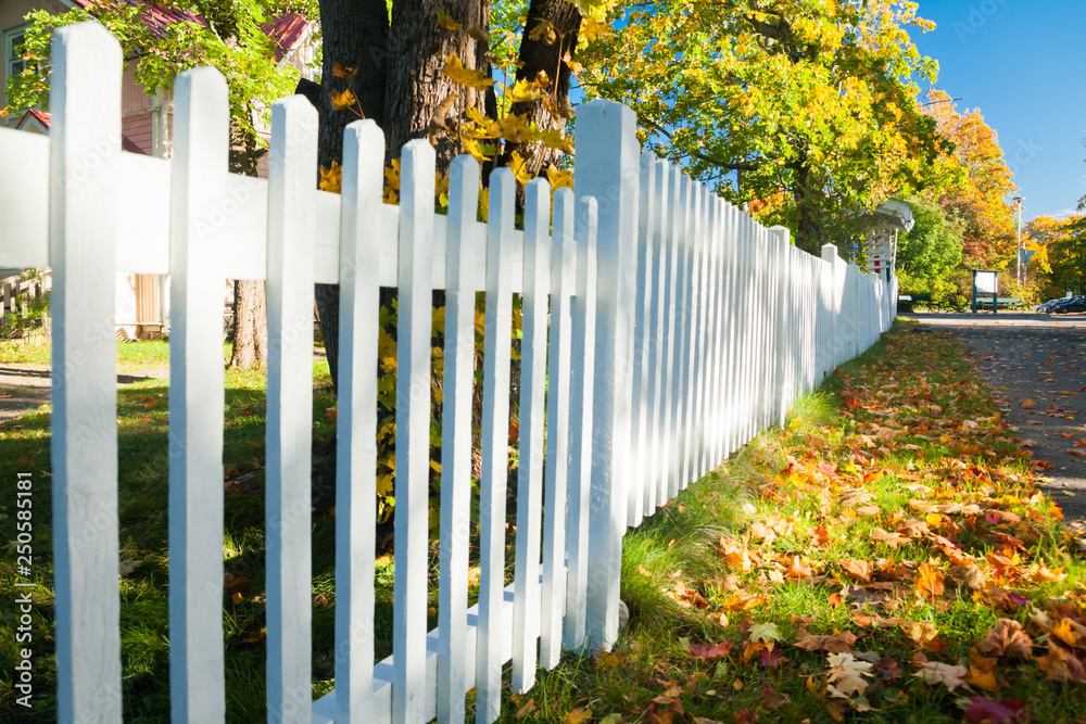 Beautiful colorful autumn scene with white fence and fall colors in ...