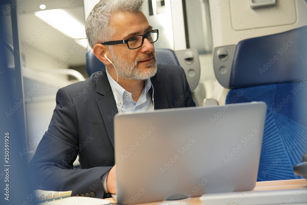 Businessman commuting by train, talking on phone Stock Photo | Adobe Stock
