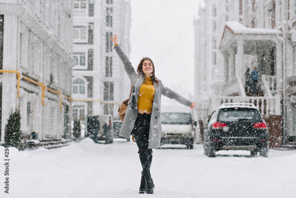 Full-length portrait of inspired female model in stylish coat posing ...