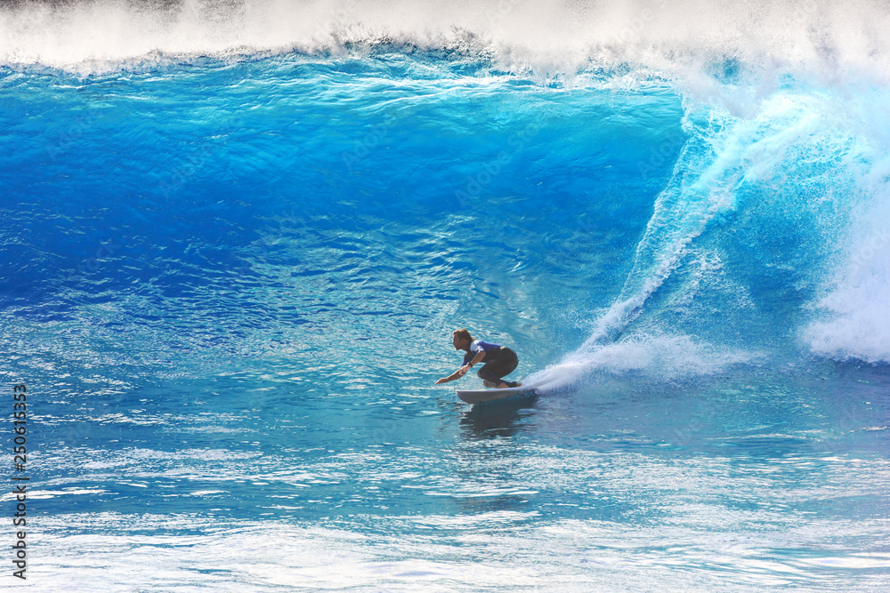 Silhouette surfer riding the big blue surf waves on the island Madeira ...