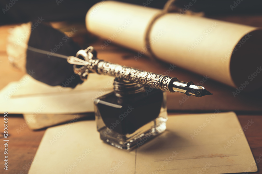 vintage feather pen with ink bottle and old paper roll Stock Photo ...