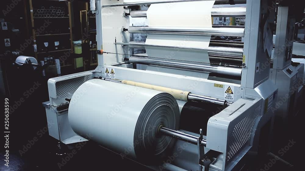 Roll of plastic sheet on industrial machine. Static shot of the ...