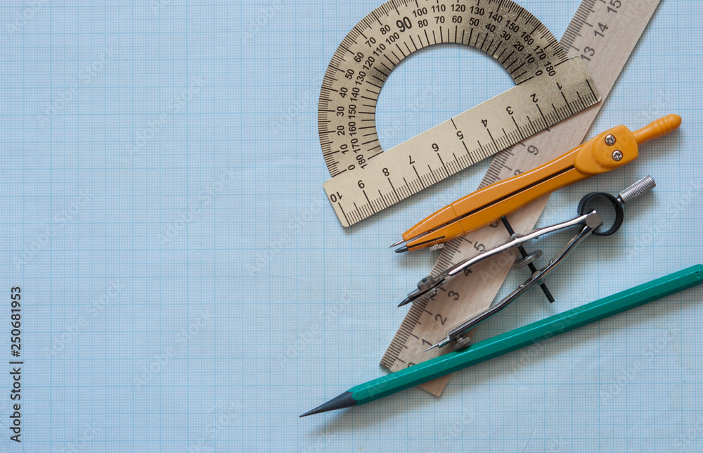 Set of drawing instrument and rulers on graph paper Stock Photo | Adobe ...