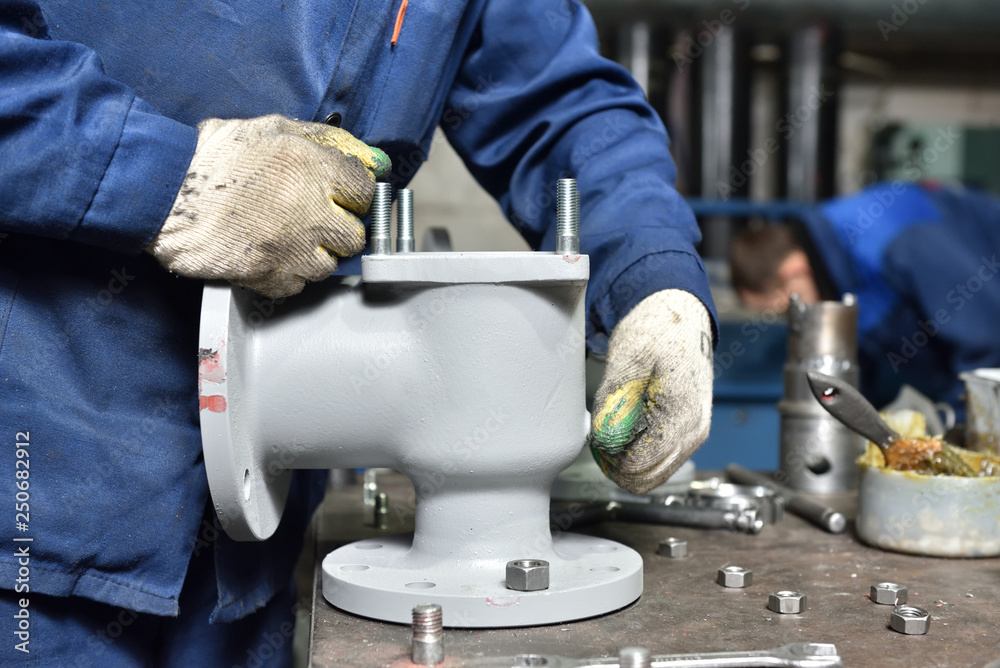 The base for the valve is mounted on an iron table for assembly at the ...