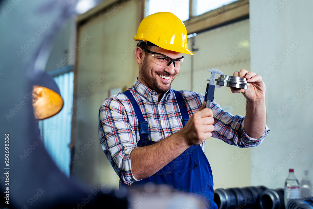 Industrial worker inspector measuring detail with Vernier Caliper Stock ...