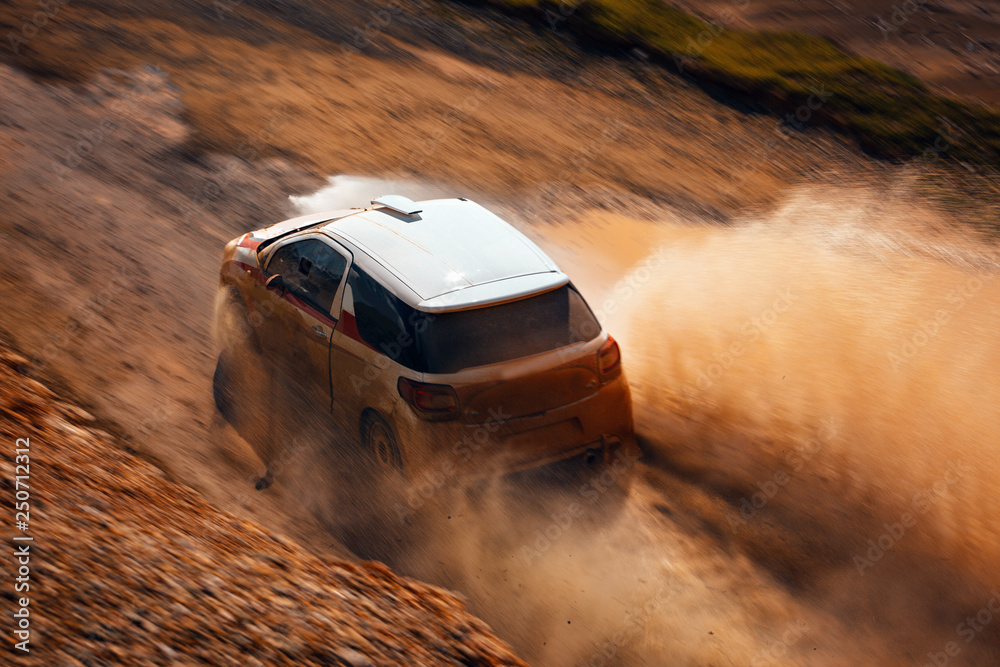 Rally vehicle going fast with mud and water splash. Car go fast at the ...