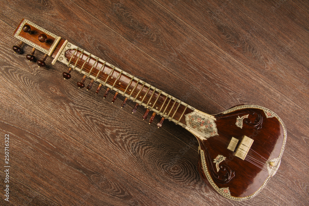 Indian musical instrument sitar lying on the wooden floor Stock Photo ...
