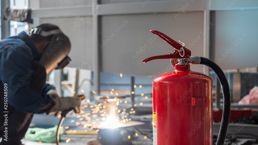 Fire extinguisher are used to prevent fire in welding steel work. Stock ...