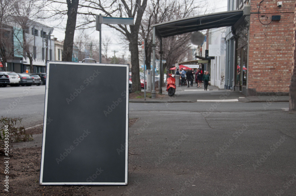 Black wooden signboard placed on a street by a real estate compa Stock ...
