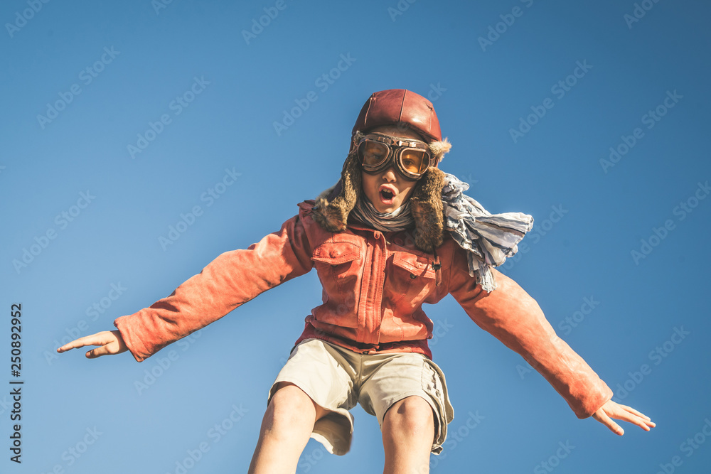 Handsome blond boy plays happy and joyful pretending to take off his ...