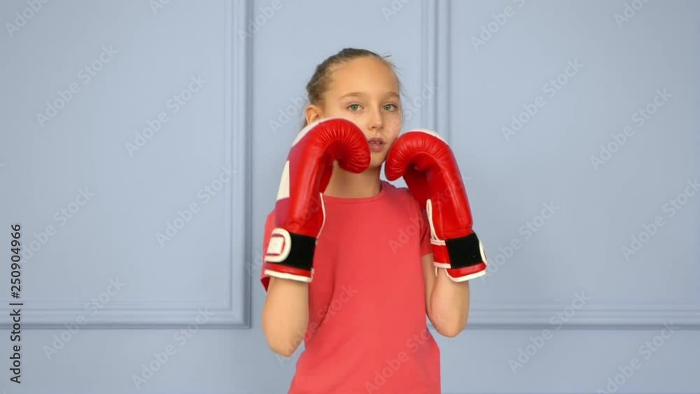 Teenager girl in red boxing gloves training fight slow motion. Fitness ...