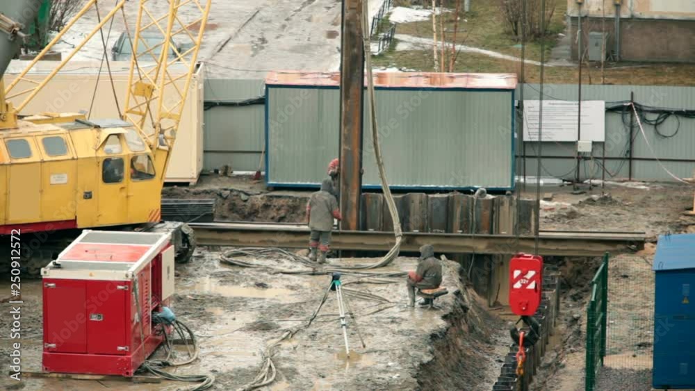 Construction Worker Teamwork, pile driving, Dam wall of sheet piling ...