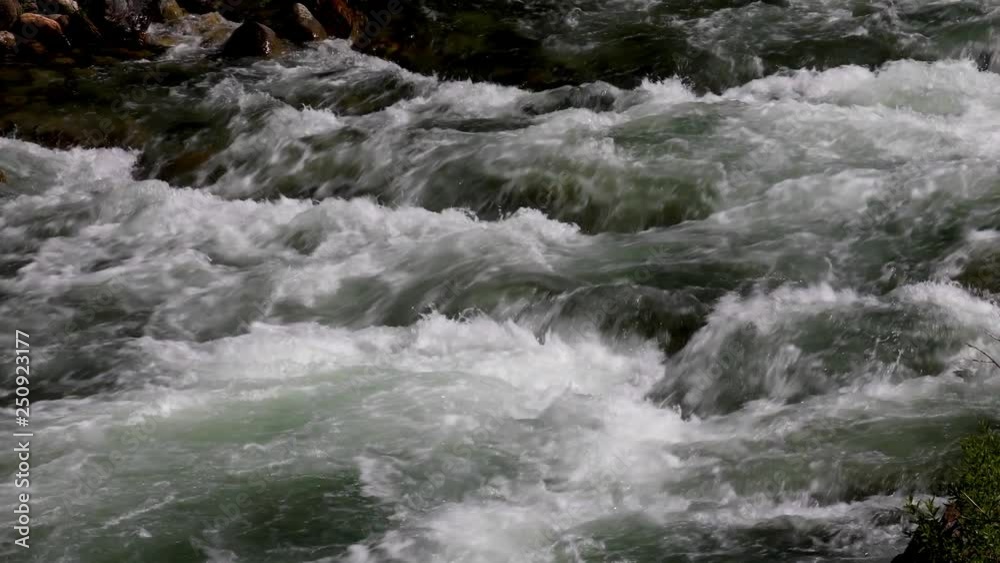Seamlessly looping footage features whitewater rapids splashing over ...