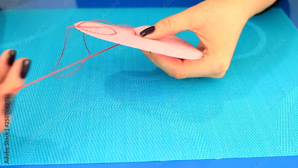 Woman Sews With A Needle And Thread.Hand Sewing Close-Up.A Hand Of A ...