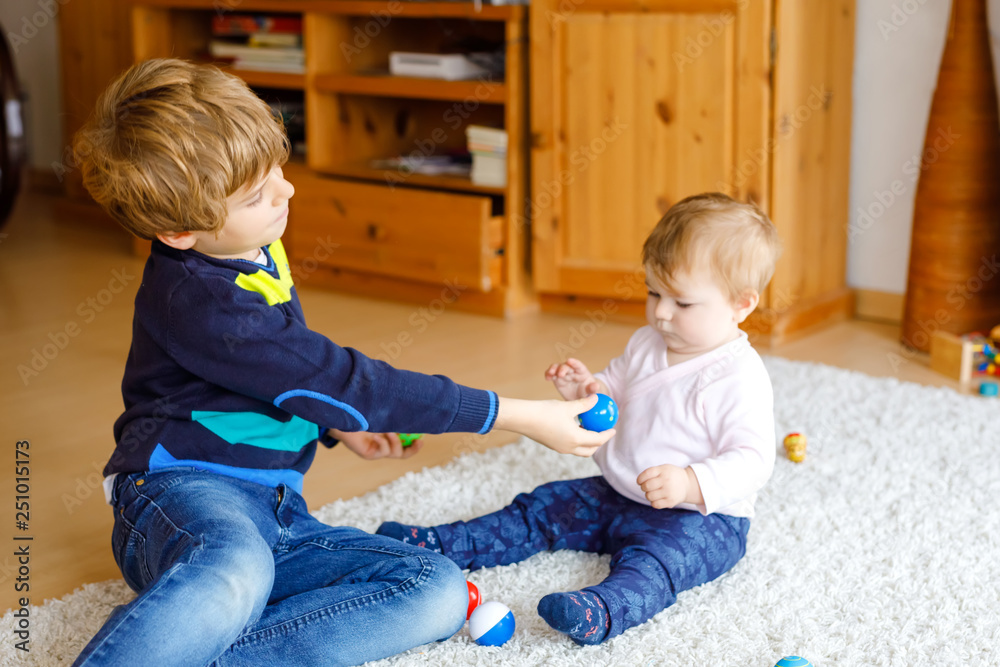 Happy little kid boy with cute little baby girl, cute sister. Siblings ...