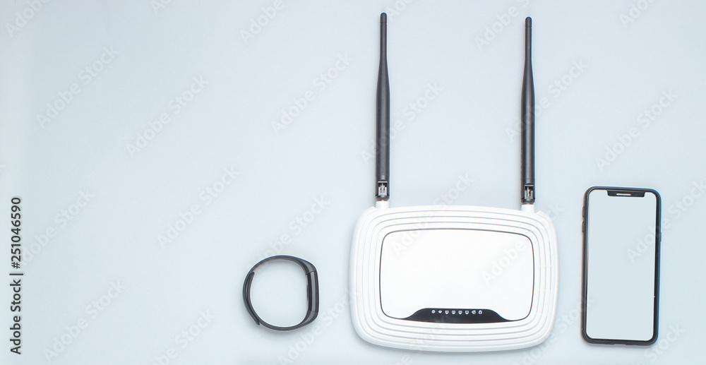 Wi-Fi router with antennas, smart phone, smart watch on a gray ...
