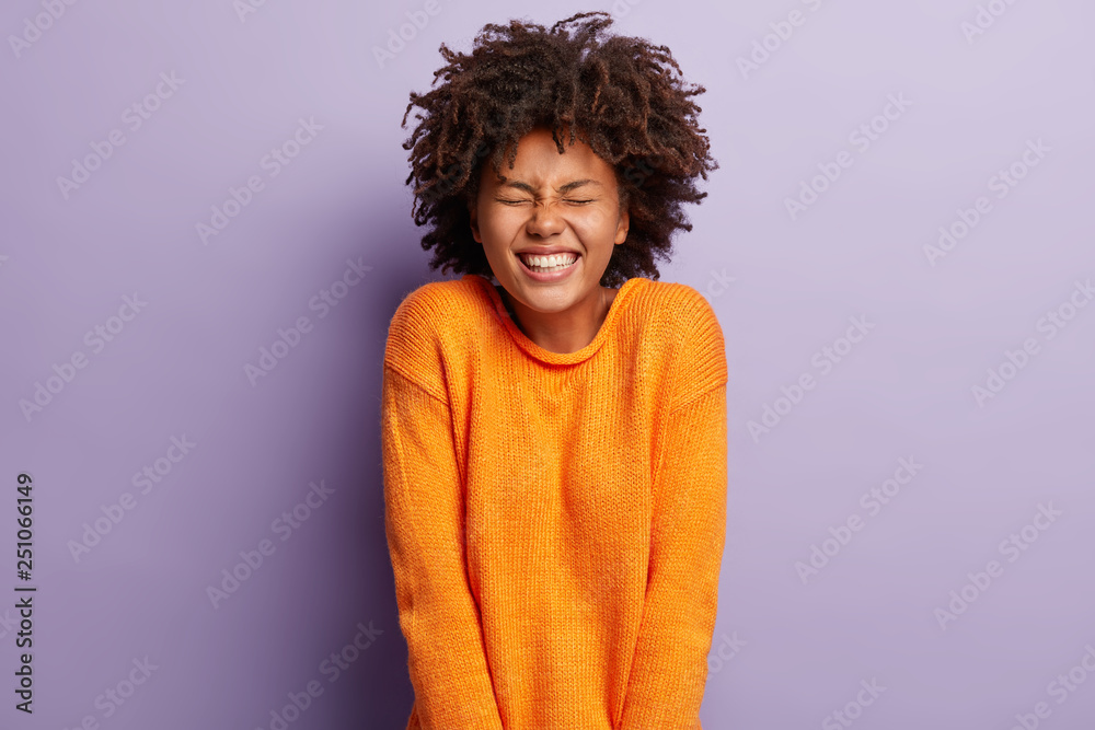 Zdjęcie Stock: Positive African American woman laughs out loudly, has ...