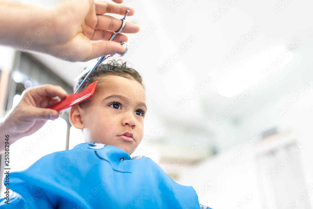 Cute Boy Getting a Hair Cut in a Barber Shop. Beauty Concept. Stock ...