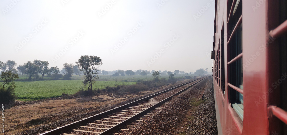 Looking out of the window of a express train of Indian railways with a ...