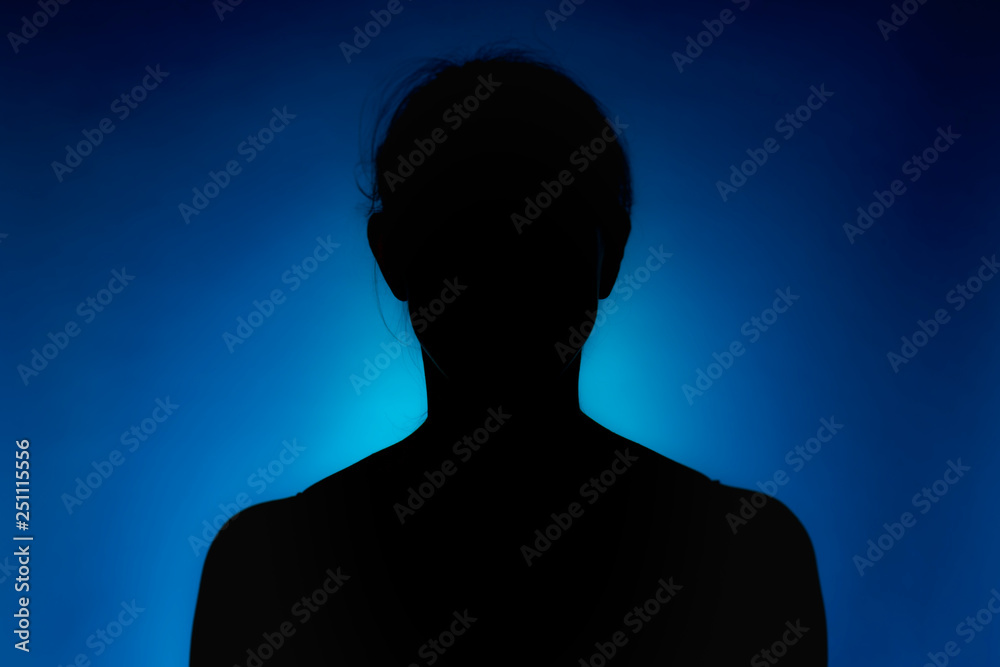 Cleanly defined silhouette of a person against a blue background with a ...