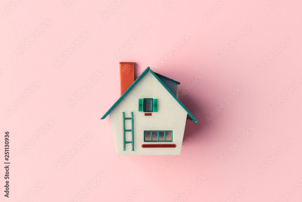 Plastic house model on pink background. Real estate concept Stock Photo ...