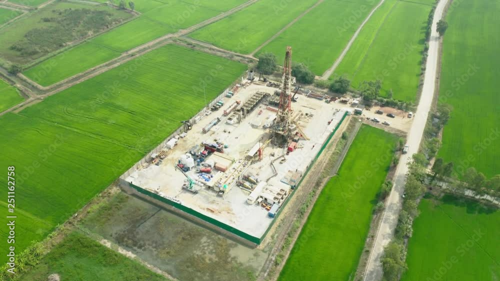 Oil and gas a land rig, onshore drilling rig, in the middle of a rice ...