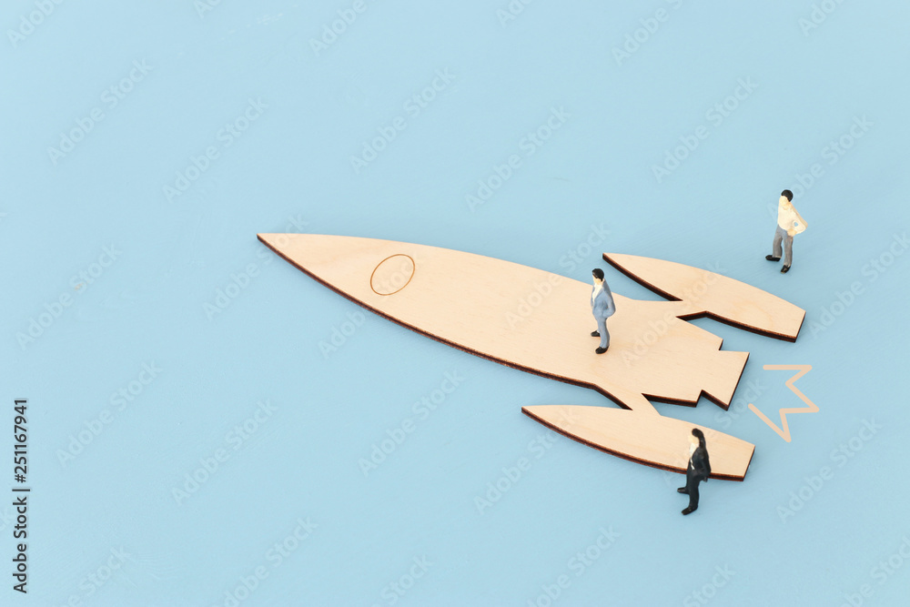 leadership and teamwork concept miniature people and rocket ...