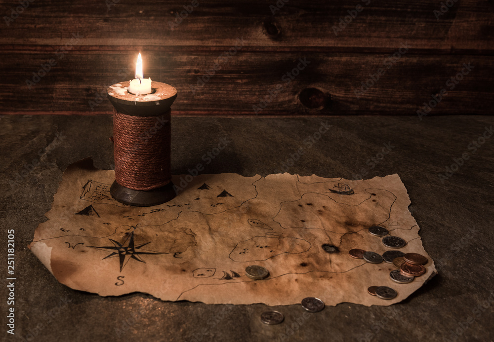 Poster old pirate map on stone table, ancient candle, many different ...