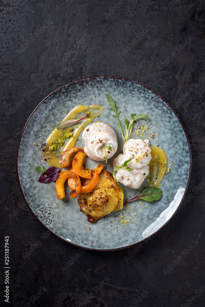 Fried Norwegian skrei cod fish filet with potatoes, pumpkin and lemon ...