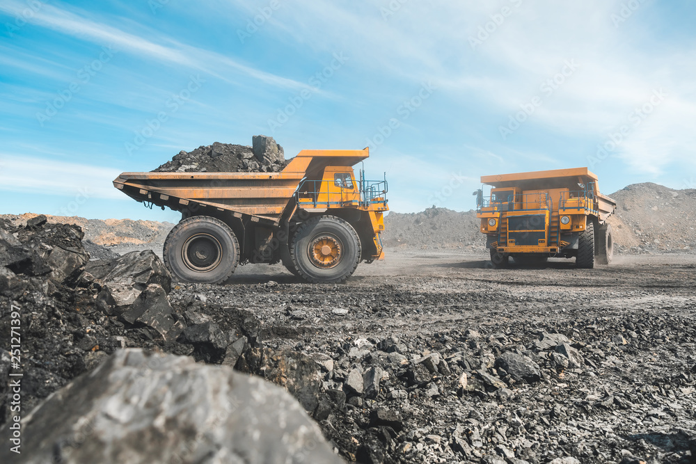 Large quarry dump truck. Loading the rock in dumper. Loading coal into ...