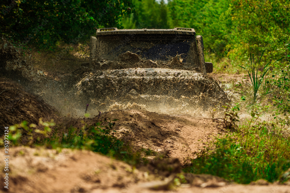 Mud and water splash in off-road racing. Tracks on a muddy field ...