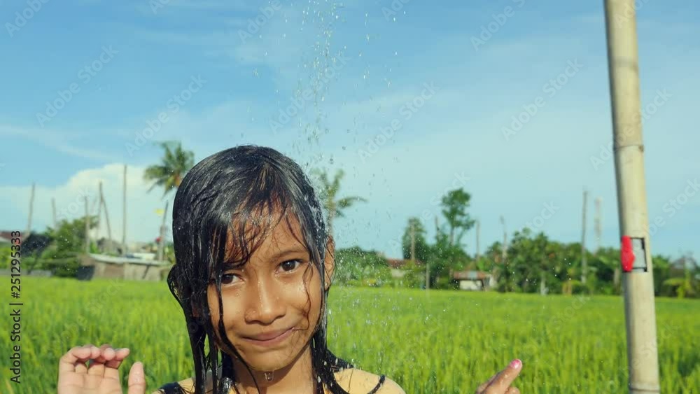 young happy and carefree beautiful Indonesian child 8 years old ...
