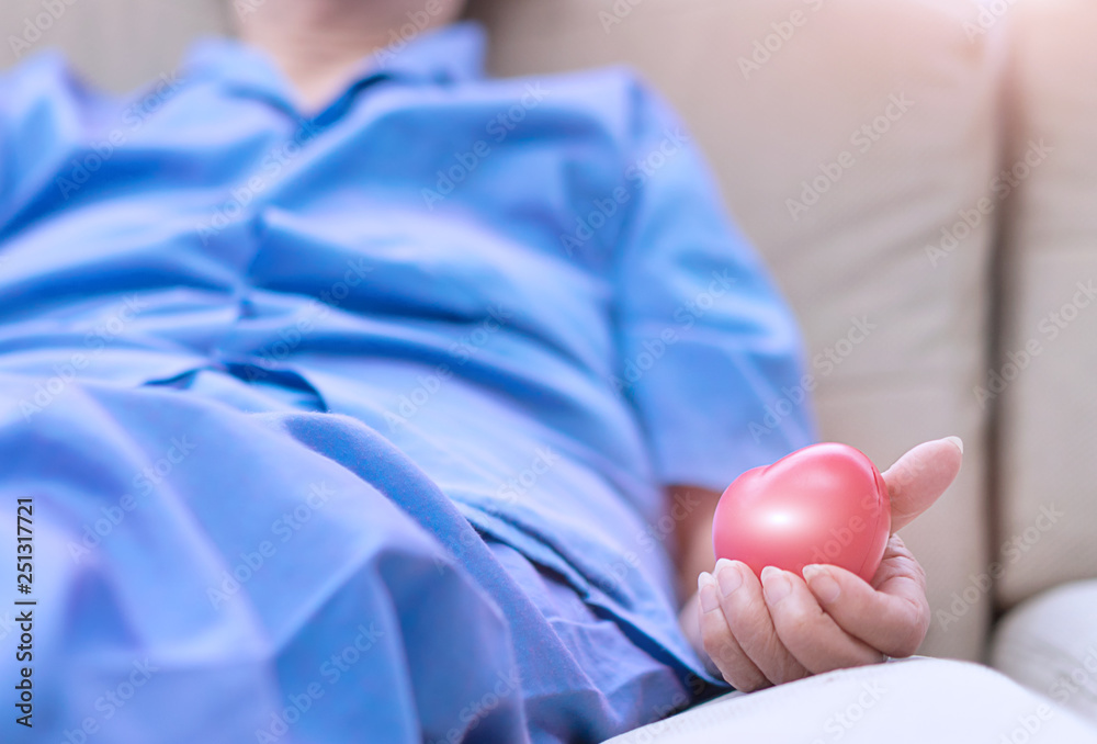 Old woman patient holding red rubber ball for exercise muscles of hand ...